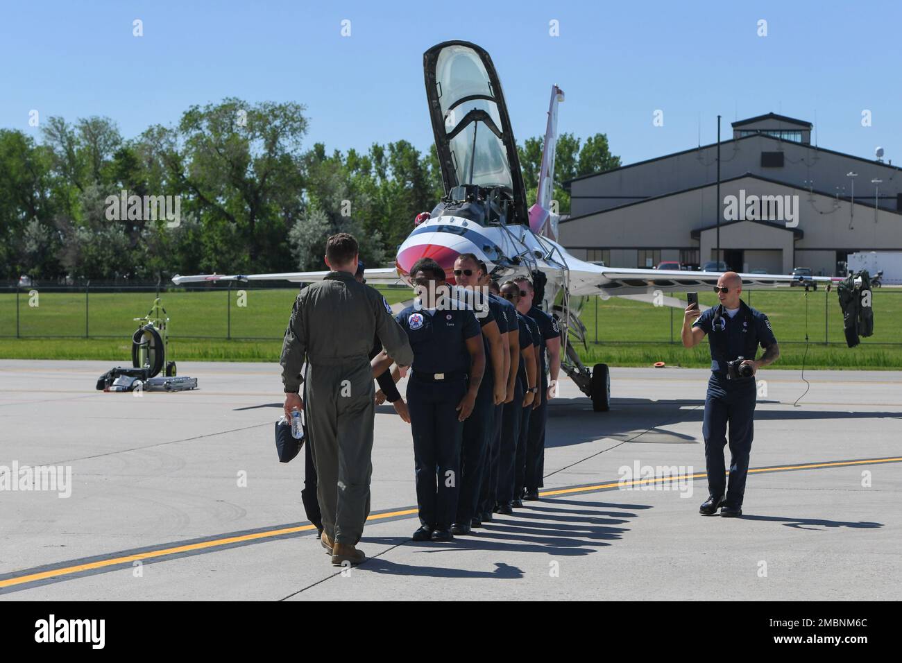 Michael Lents, University of North Dakota flight instructor, is greeted ...