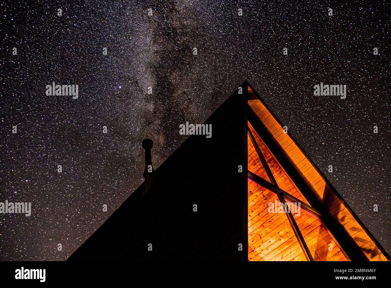 Milky way above an A Frame solar cabin Stock Photo - Alamy
