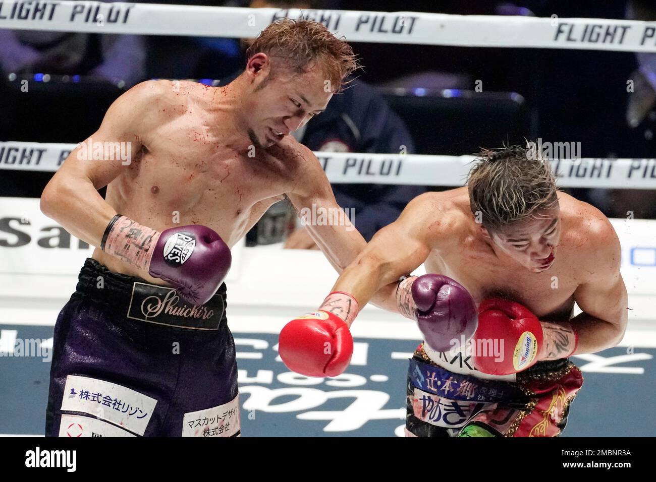 Japan's Shuichiro Yoshino sends a left to compatriot Masayuki Ito during their WBO Asia Pacific ...