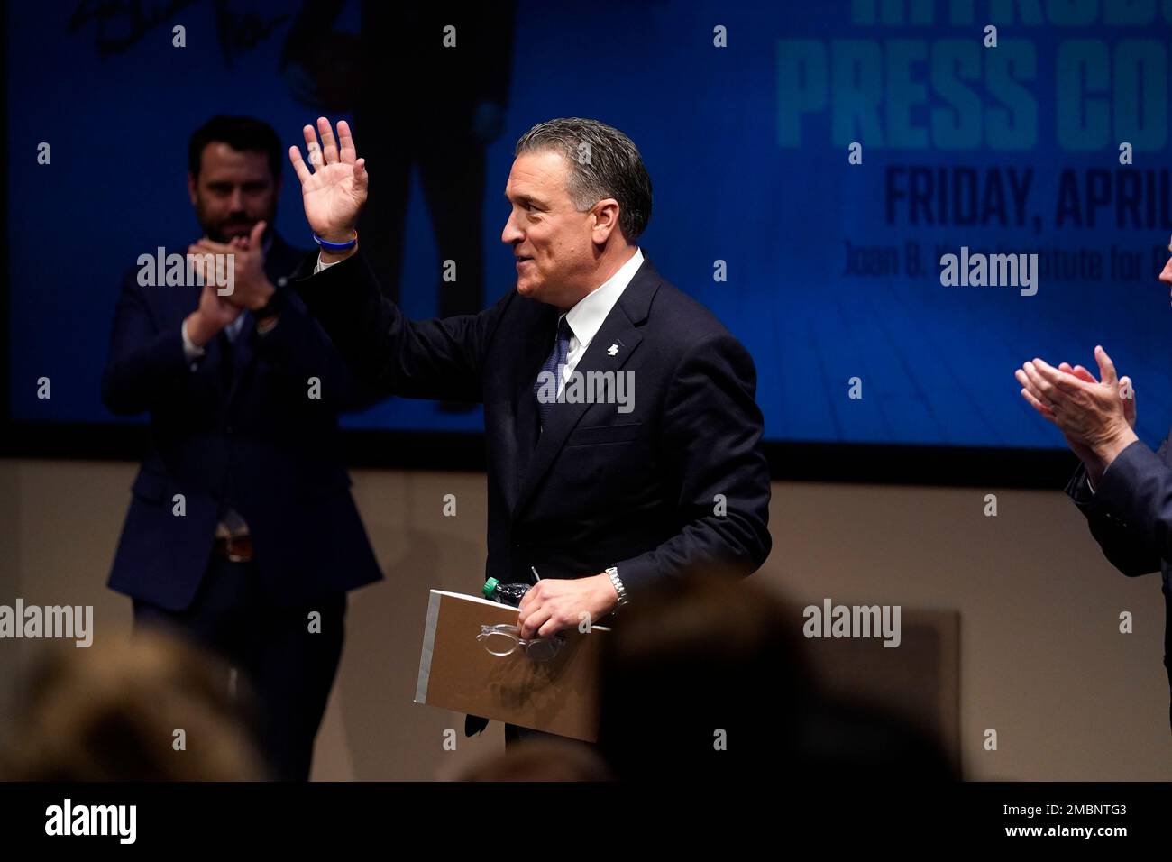 San Diego's new men's basketball coach, Steve Lavin, waves during a ...