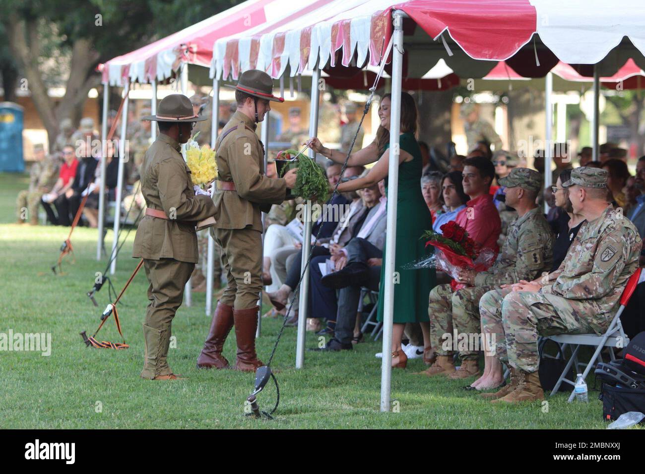 Capt. John Trainor receives a bucket of carrots and beer for the horses ...