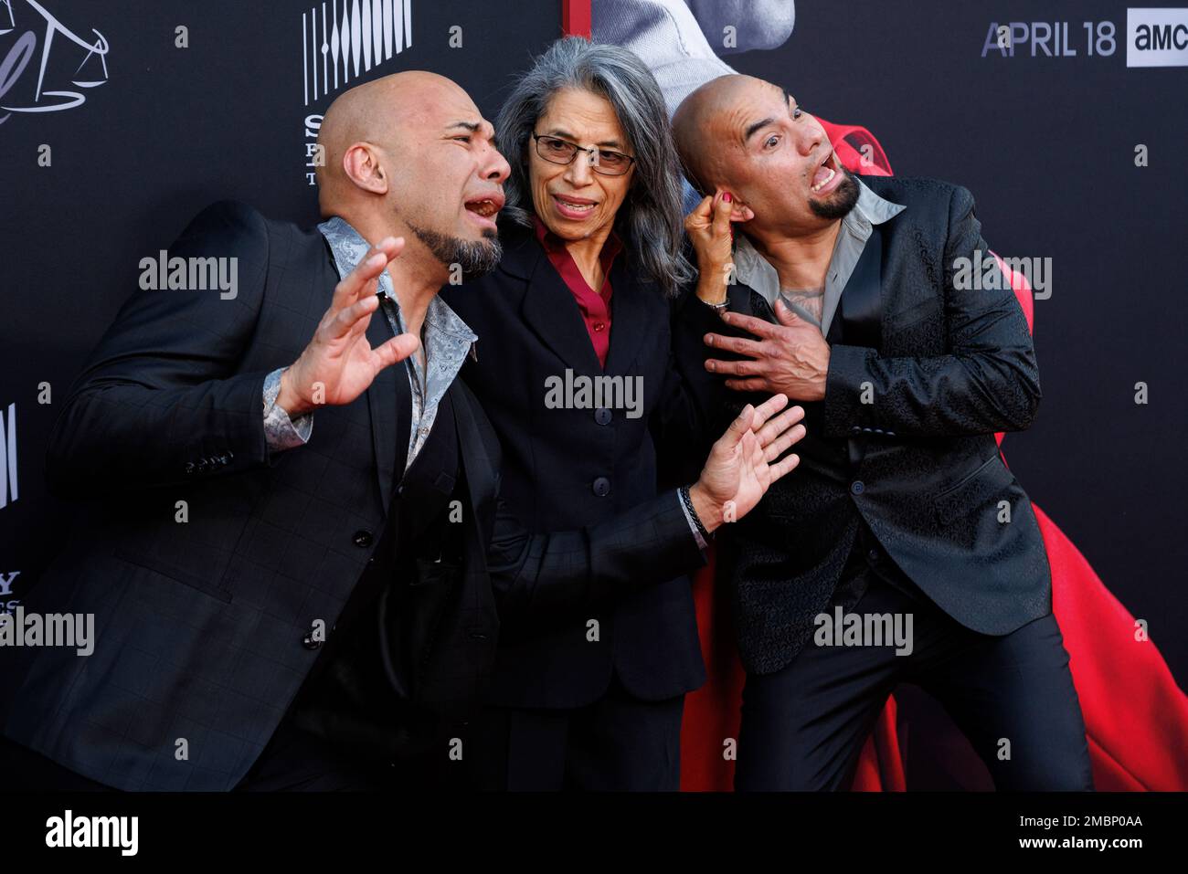 Luis Moncada, left and Daniel Moncada joke around with their mother as ...