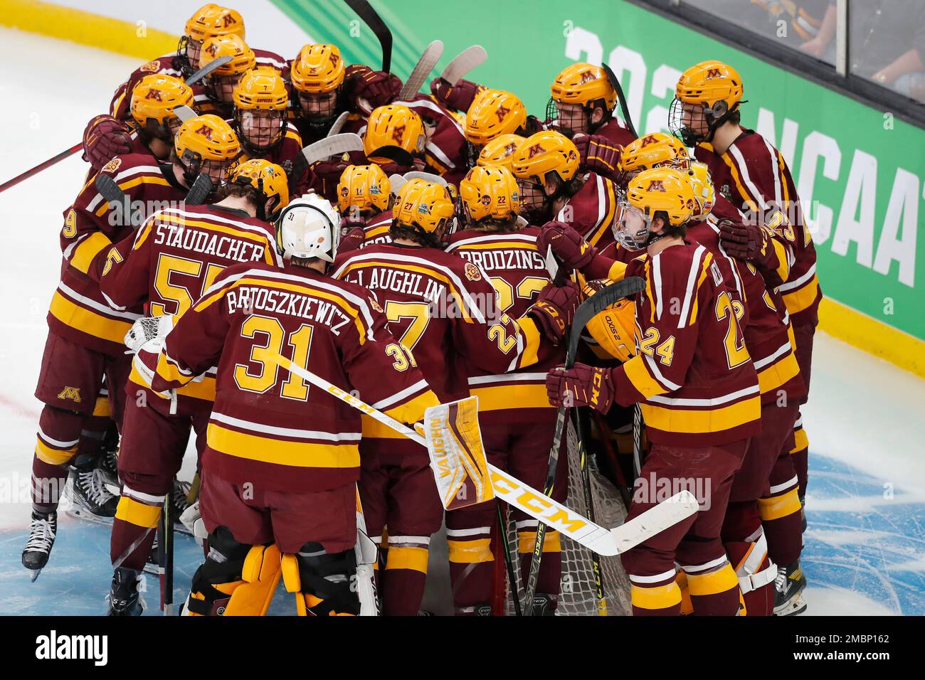 Minnesota players huddle before an NCAA men's Frozen Four semifinal ...