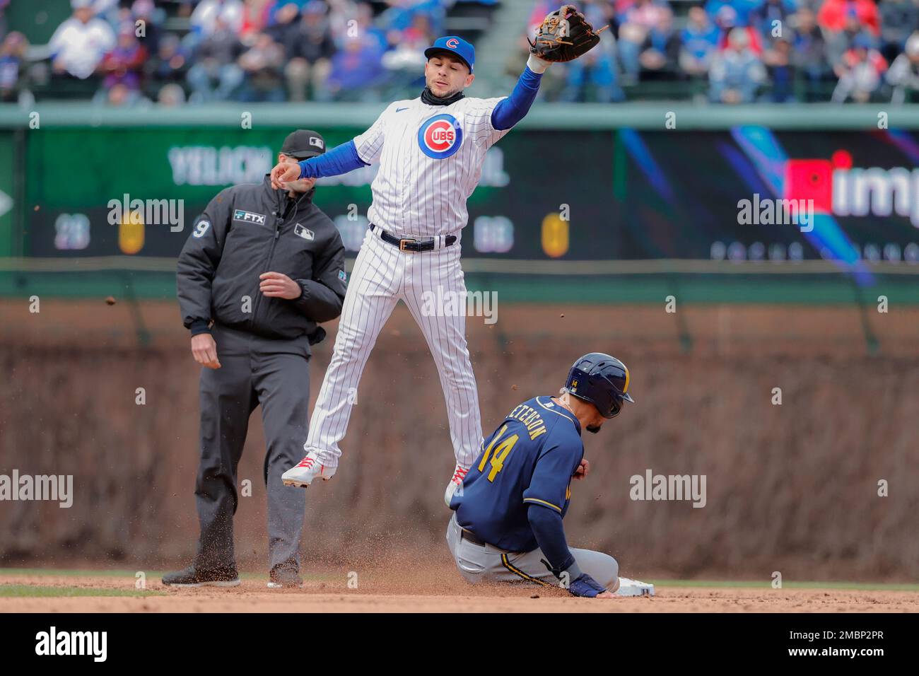 Milwaukee Brewers' Jace Peterson, right, steals the second base against ...