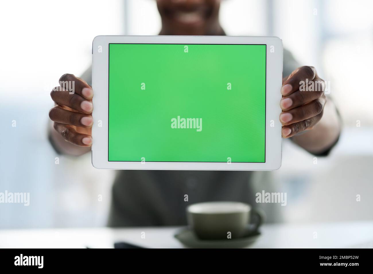 Want to see something cool. a young man showing a tablet at work Stock ...