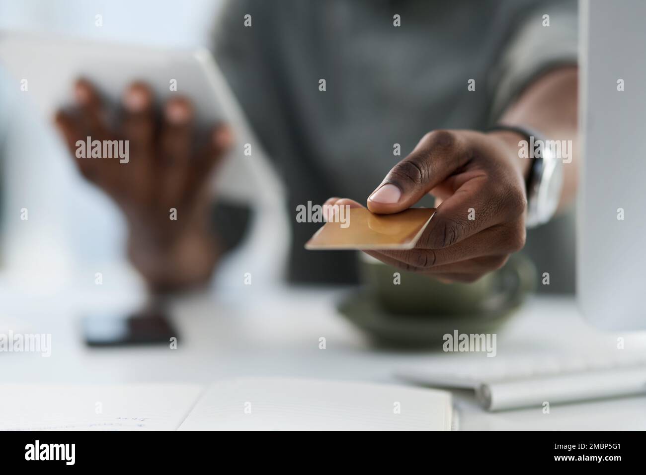 Ill swipe thanks. a young man giving a bank card at work Stock Photo ...
