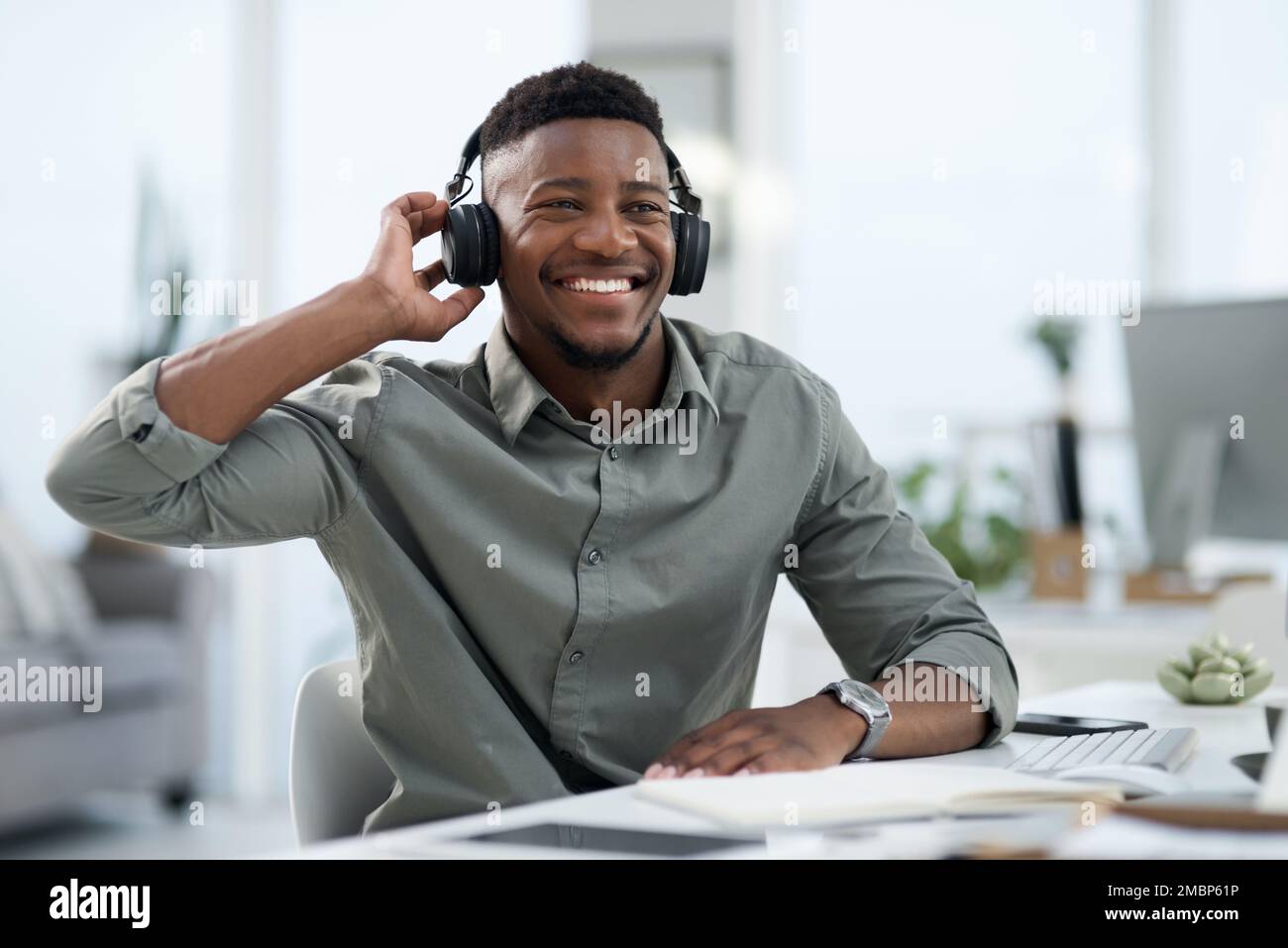 Top agent for the month. a young man on a call at work in a office ...