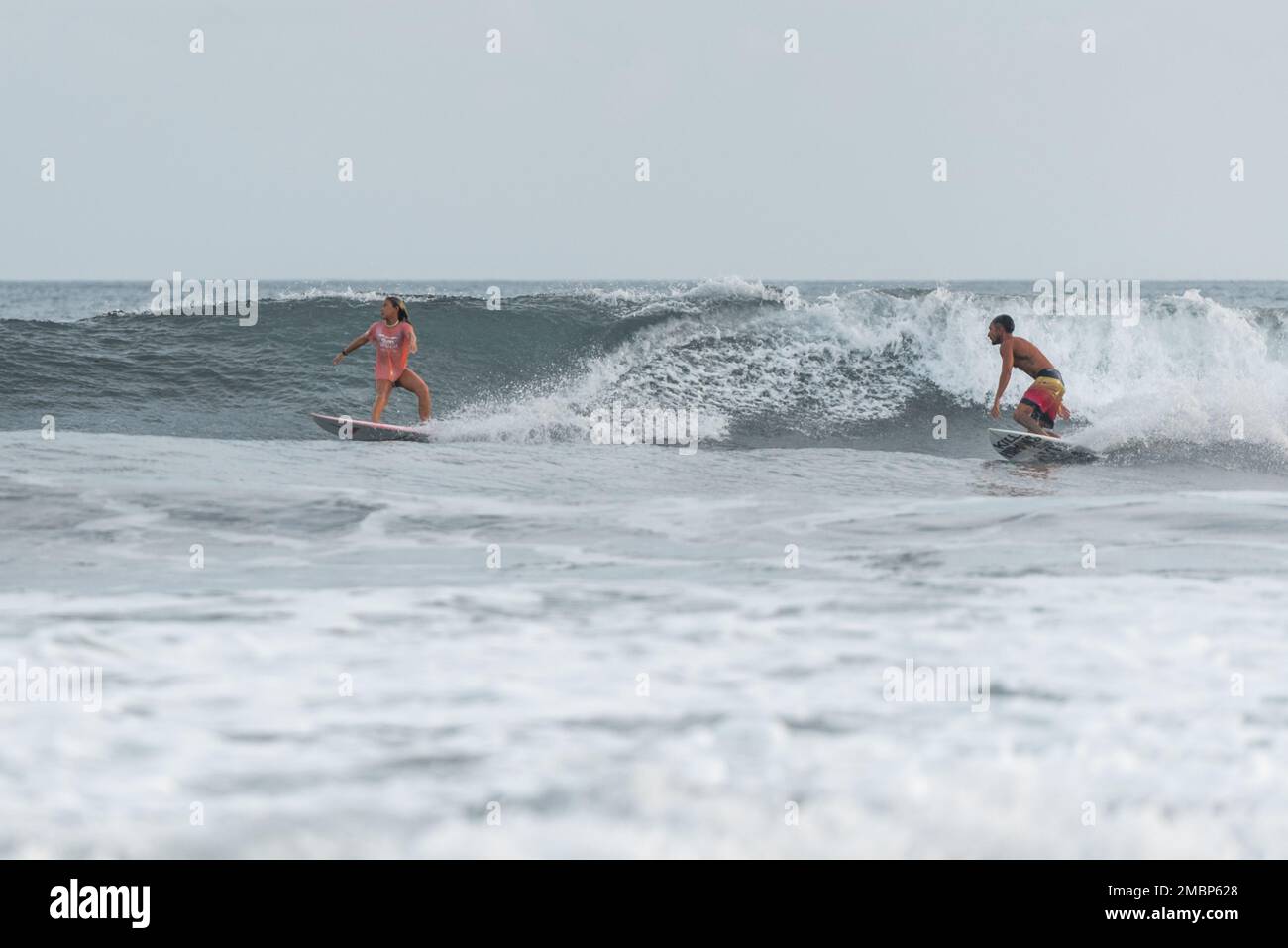 Surf in Keramas beach, Bali, Indonesia, Man and Women surfing waves ...