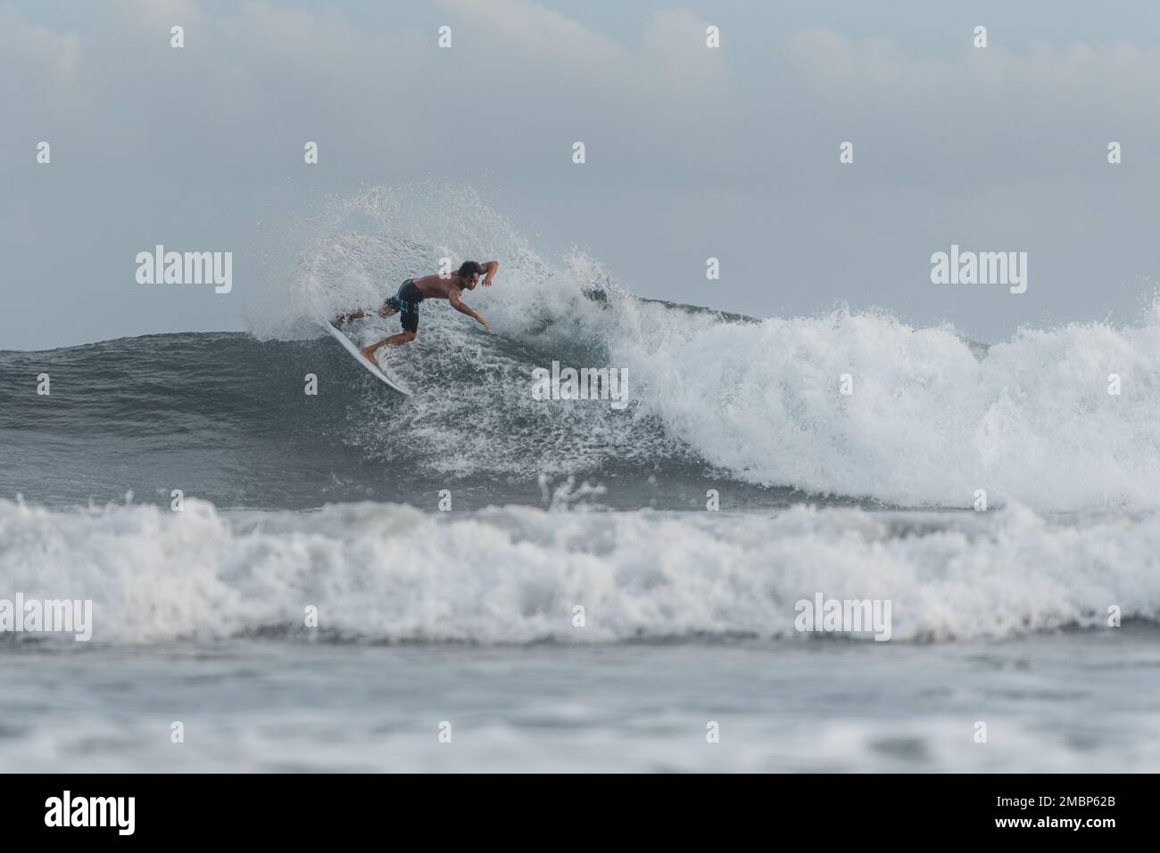 Surf in Keramas beach, Bali, Indonesia, Man and Women surfing waves ...