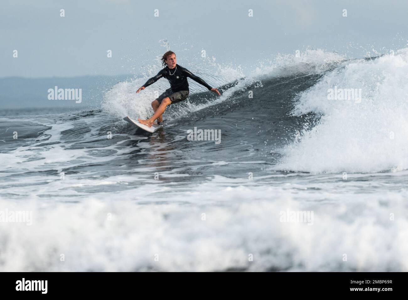 Surf in Keramas beach, Bali, Indonesia, Man and Women surfing waves ...