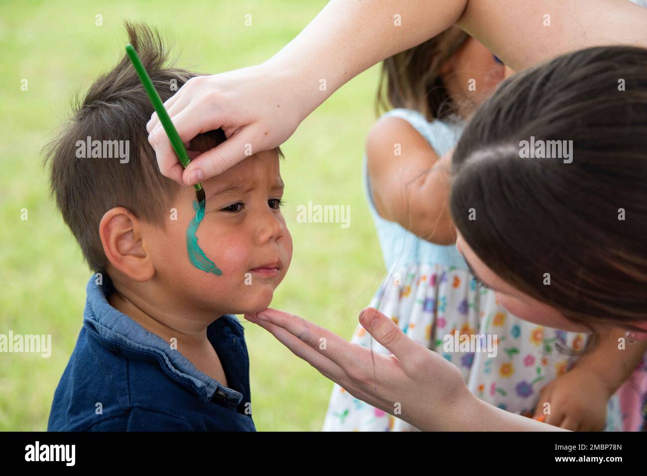 A child from a 97th Air Mobility Wing family gets his face painted ...
