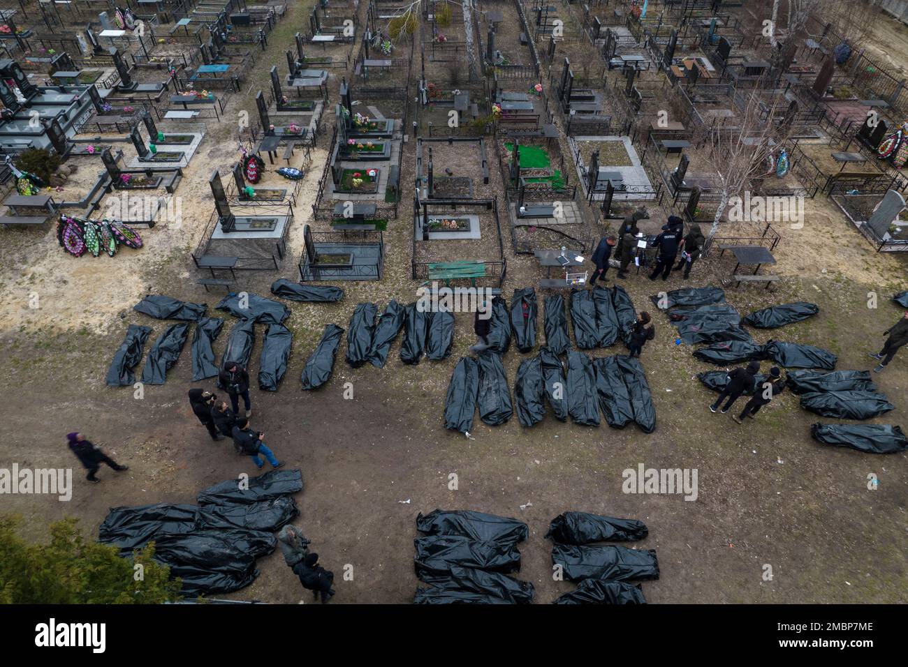 Policemen work on the identification process following the killing of ...