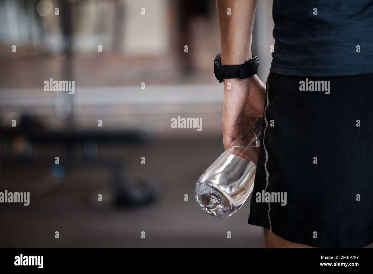 Water bottle, fitness and gym sports of a man at a wellness, training ...