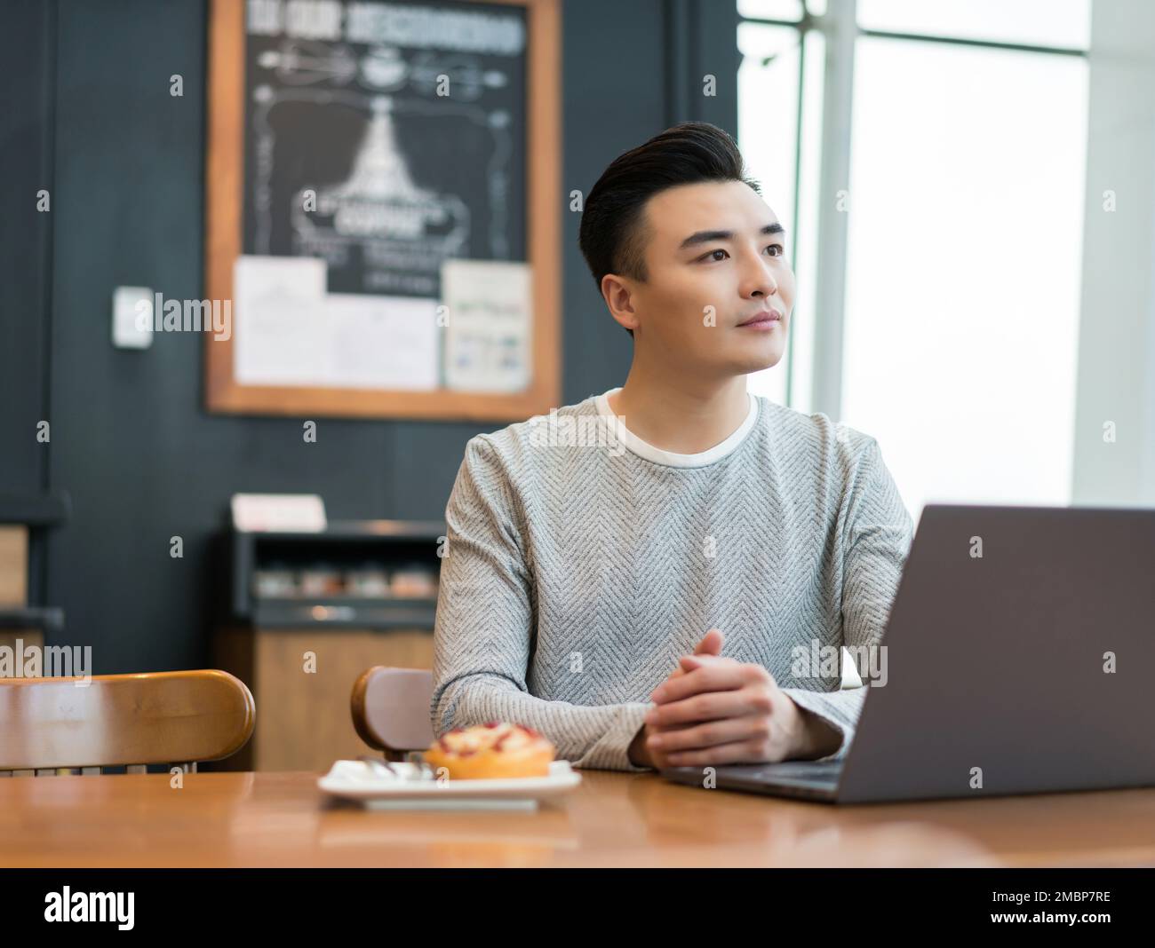 Young men who use a computer in a restaurant Stock Photo - Alamy