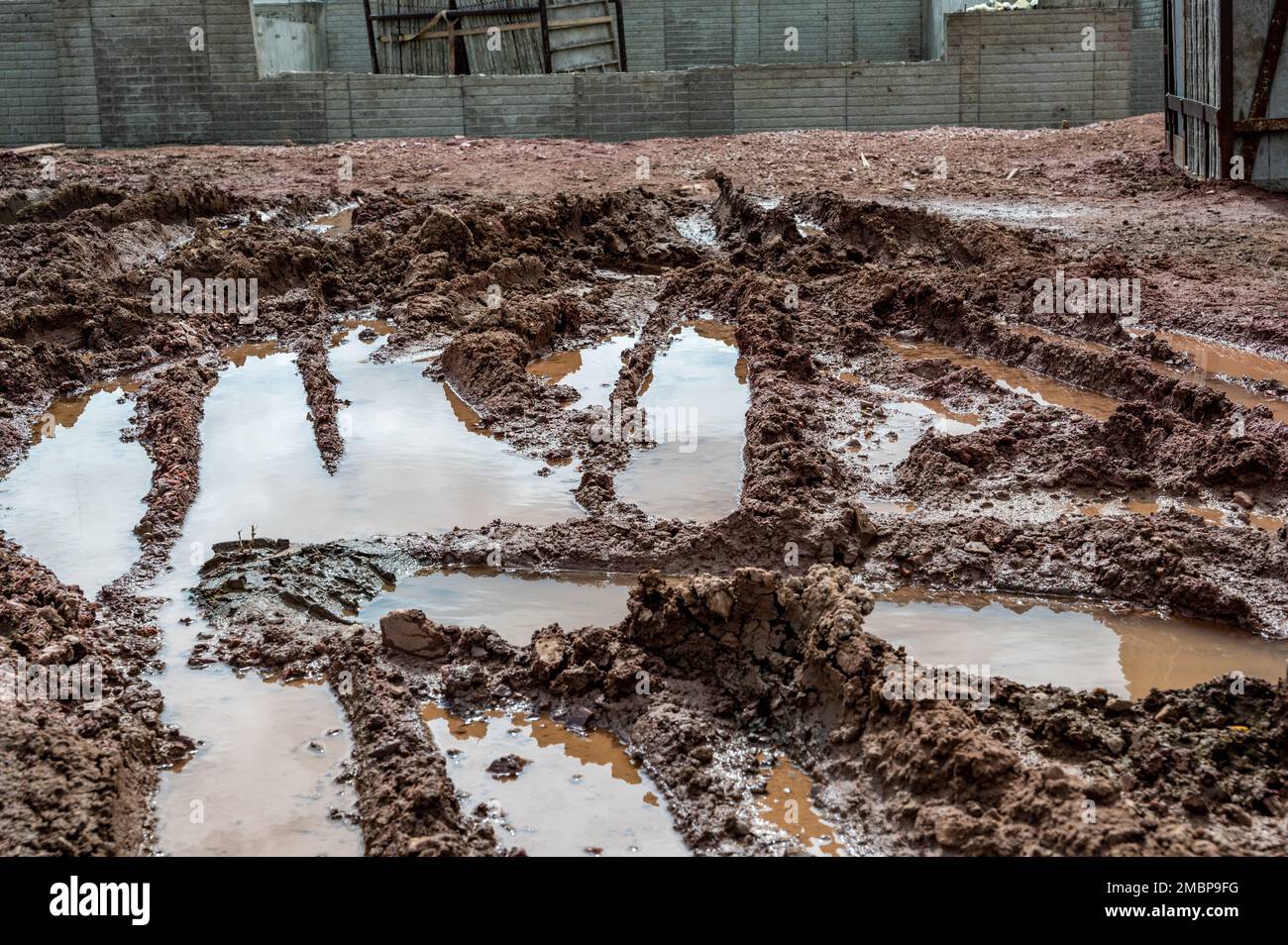 residential house construction under rain delay with mud and tracks ...