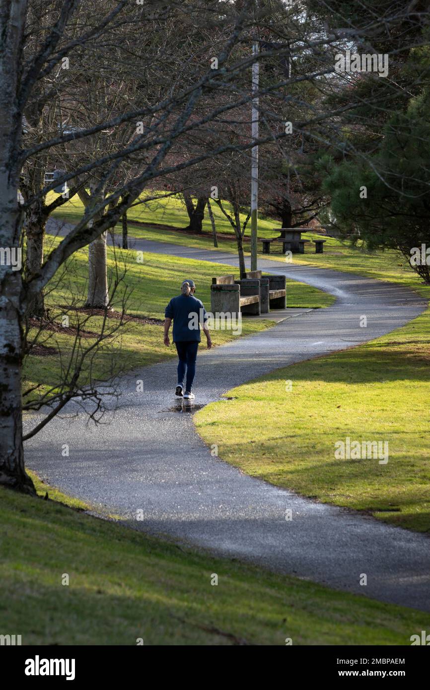 A woman walks along the Cedar River Trail after a rainstorm in Renton ...