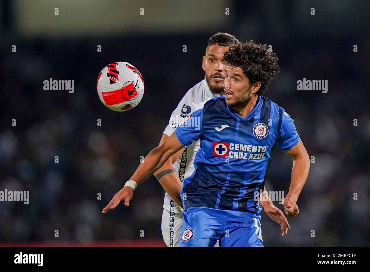 Ignacio Rivero of Mexico's Cruz Azul, front, eyes the ball chased by ...