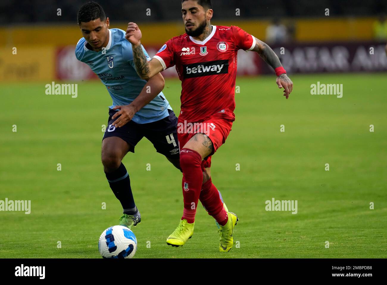 Kevin Minda of Ecuador's Universidad Catolica, left, fights for the ...