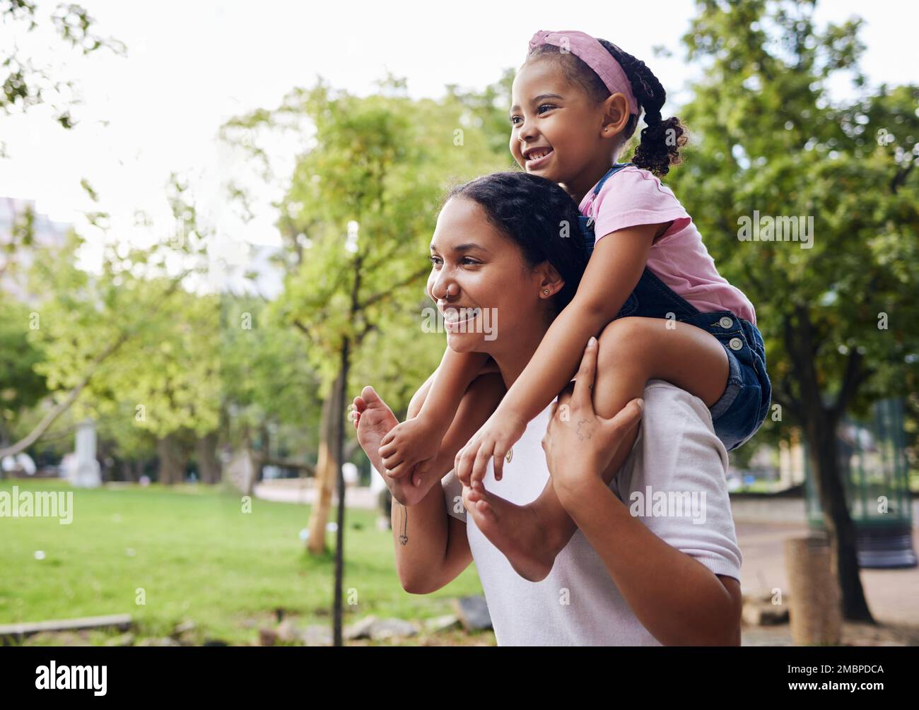 Back, mother carry girl and in park for fun, happiness and bonding on ...