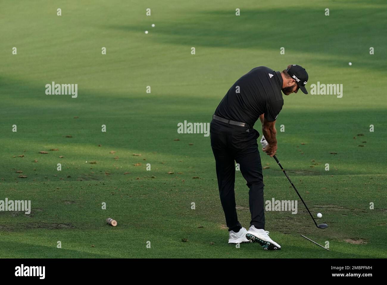 Dustin Johnson hits on the driving range during a practice round for ...