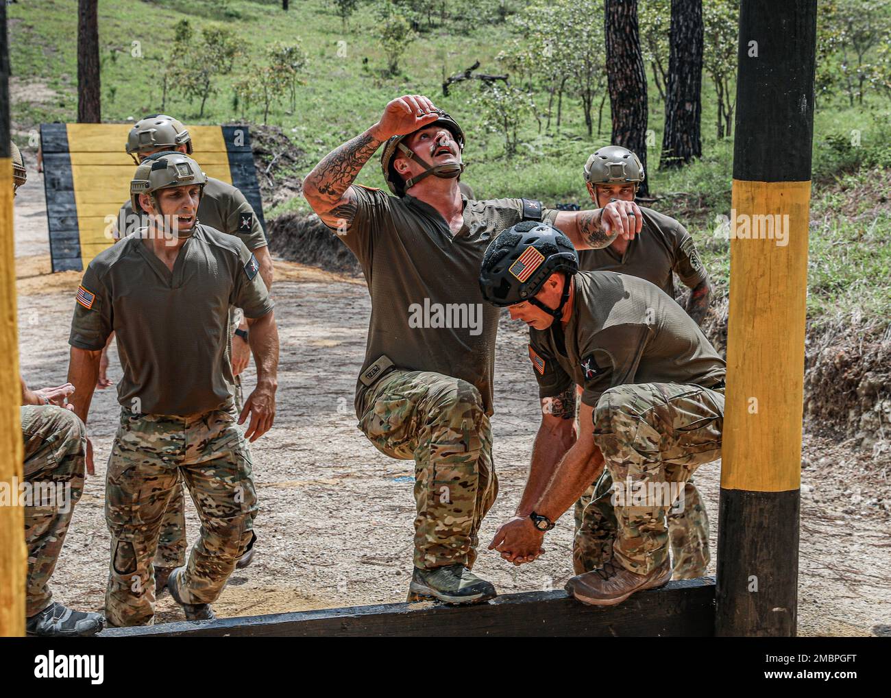 The United States team prepares to climb an obstacle during the ...