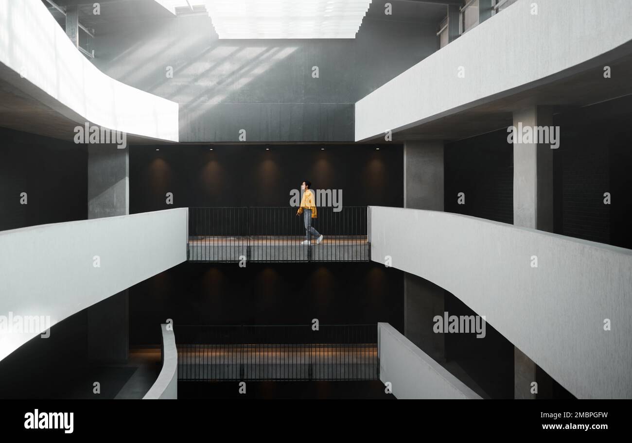 Architecture, lighting and walking woman in a building for work ...