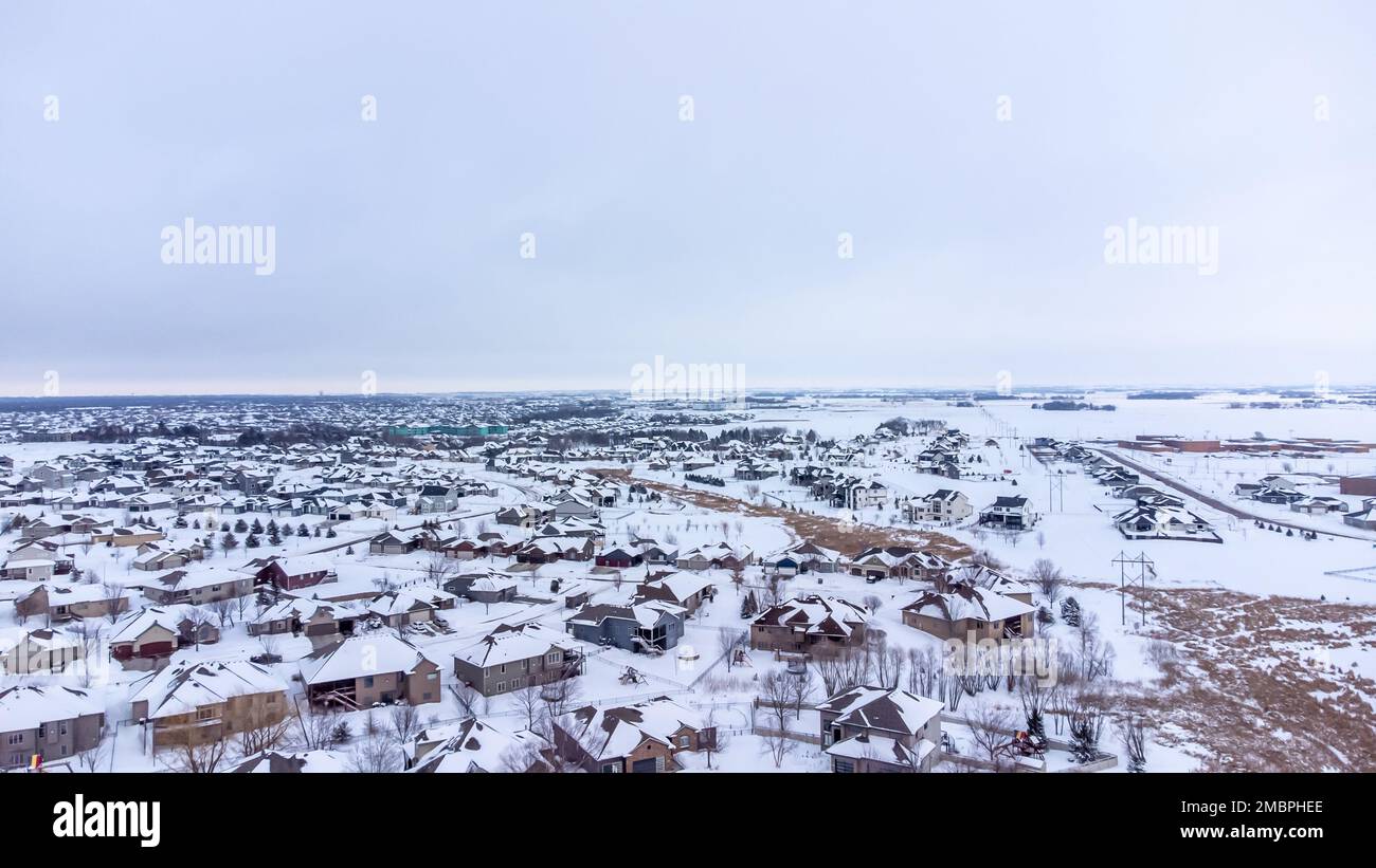 Aerial drone view of a snow covered suburban residential neighborhood ...