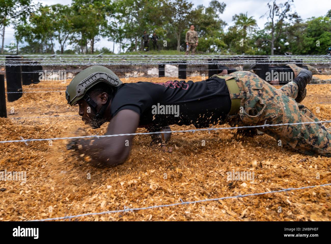 Partner nation team members participate in the obstacle course as part ...