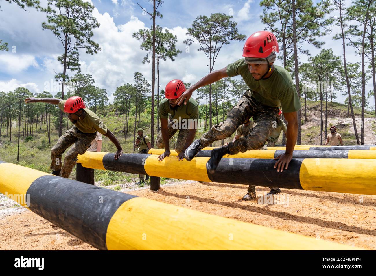 Partner nation team members participate in the obstacle course as part ...