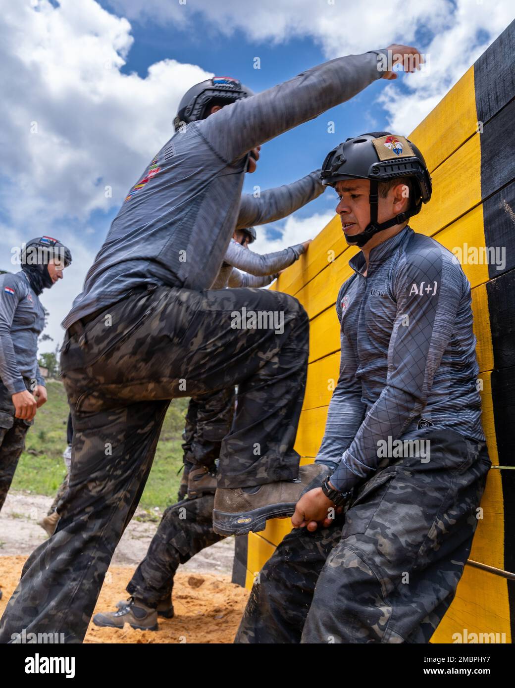 Paraguayan team members participate in the obstacle course as part of ...