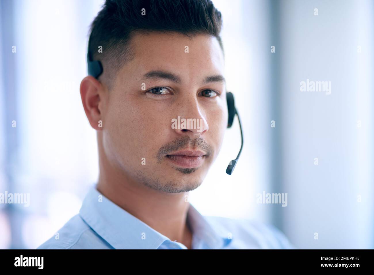 Lets speak and get it sorted. a young man using a headset in a modern ...