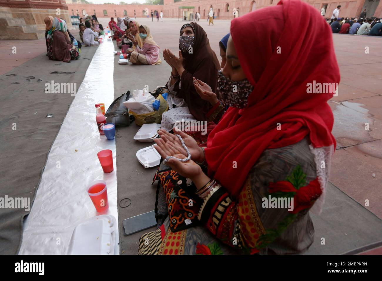 Women pray prior to breaking their fast during the Muslim holy fasting ...