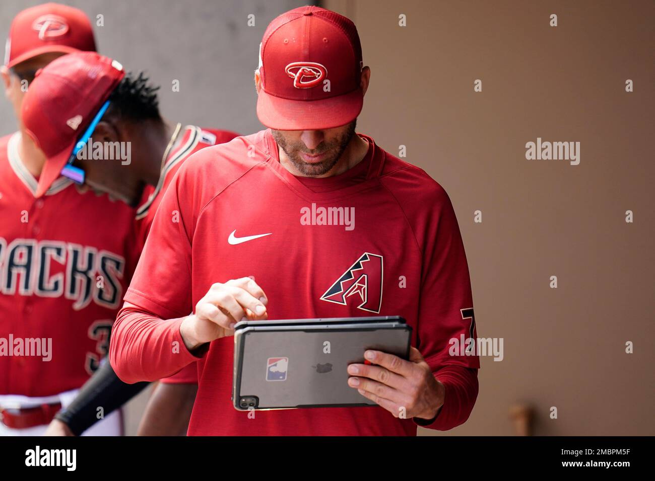 Arizona Diamondbacks hitting coach Joe Mather examines information on a ...
