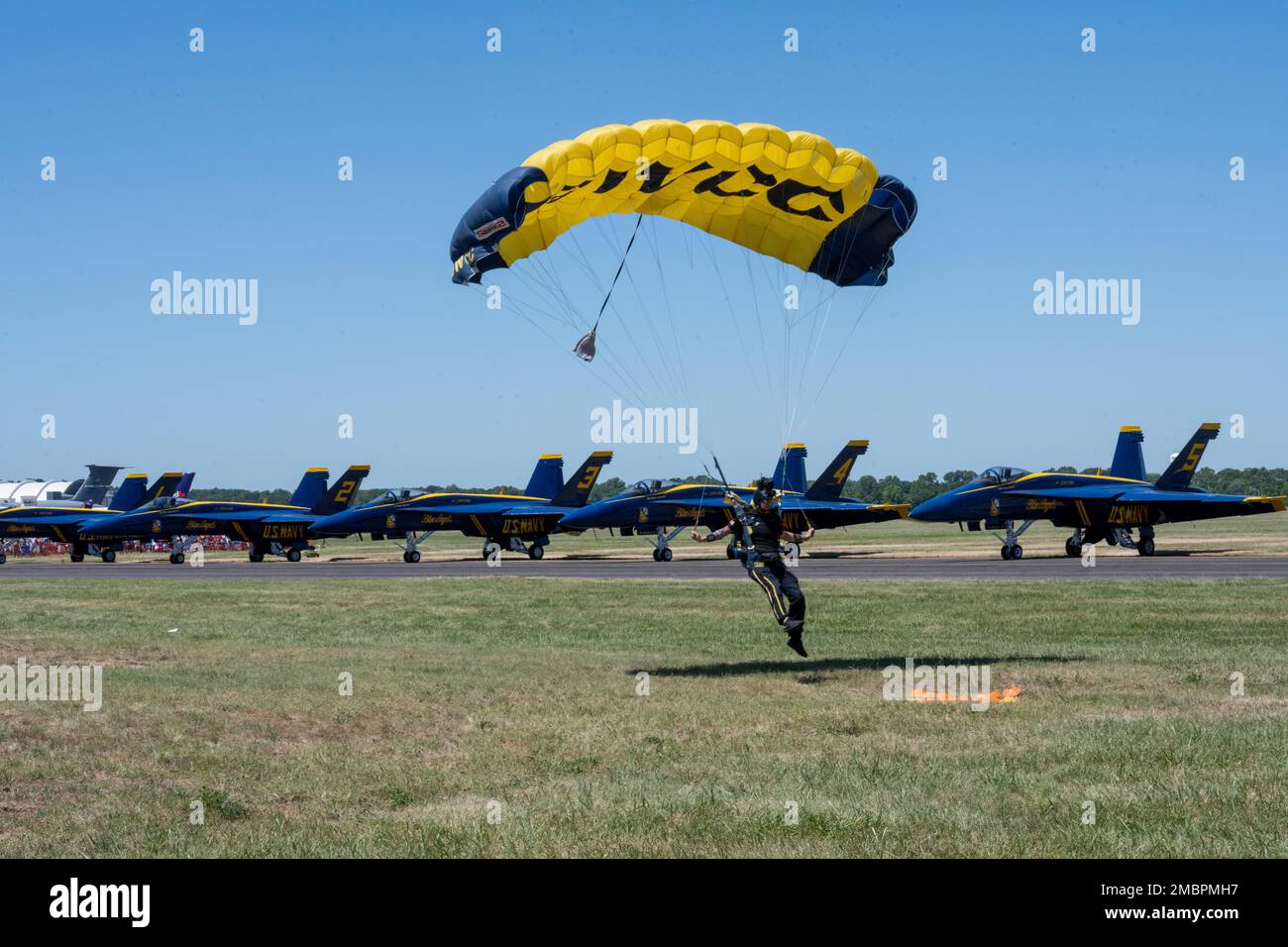 A member of the Navy Parachute Team, the “Leap Frogs,” parachutes into ...