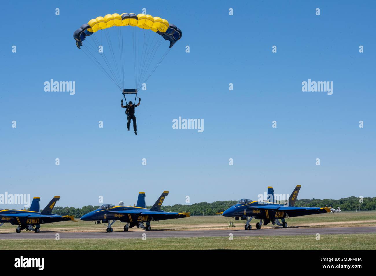 A member of the Navy Parachute Team, the “Leap Frogs,” parachutes into ...