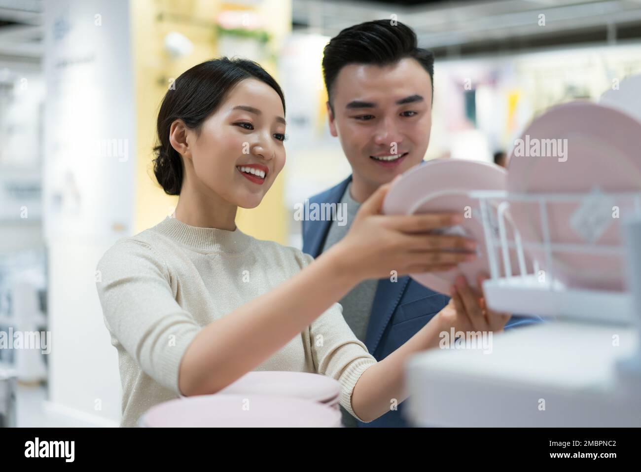 A young couple of choose and buy household items Stock Photo - Alamy