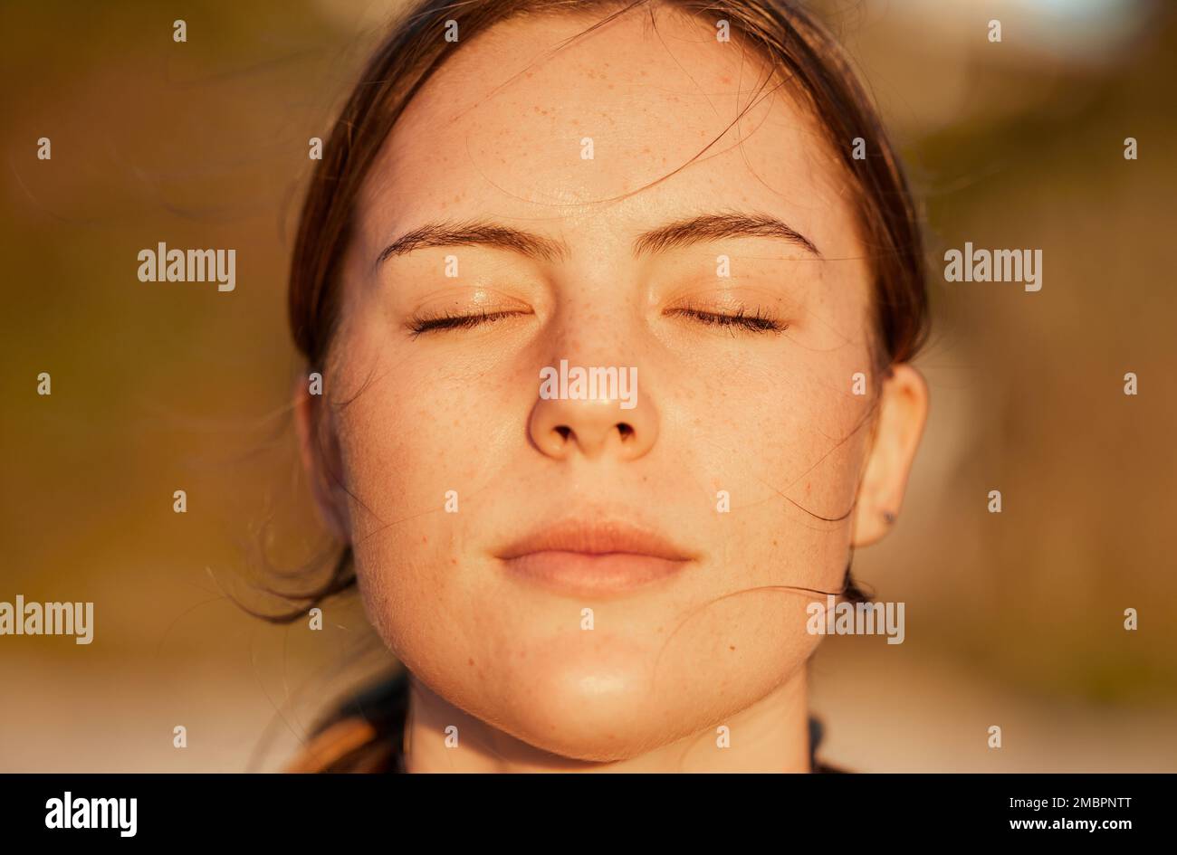 Face, relax and peace with a woman outdoor in nature, standing alone for zen, calm or serenity ...