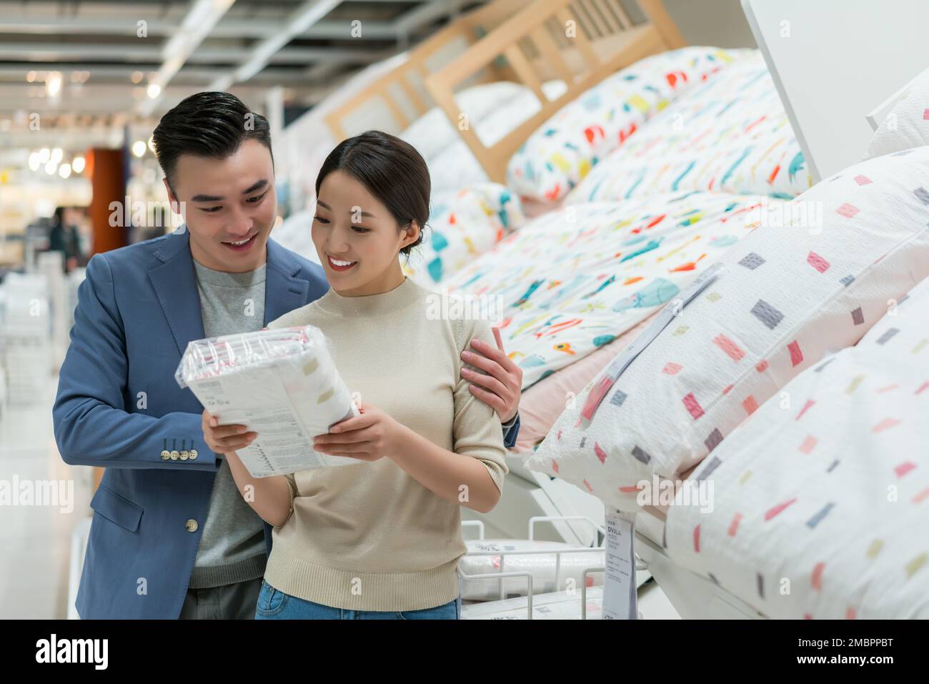 A young couple of choose and buy household items Stock Photo - Alamy