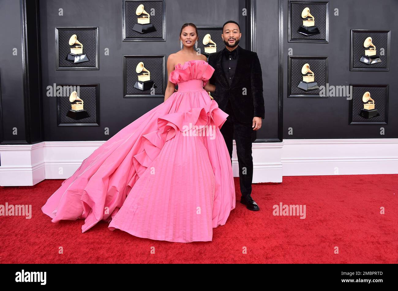 Chrissy Teigen, left, and John Legend arrive at the 64th Annual Grammy ...