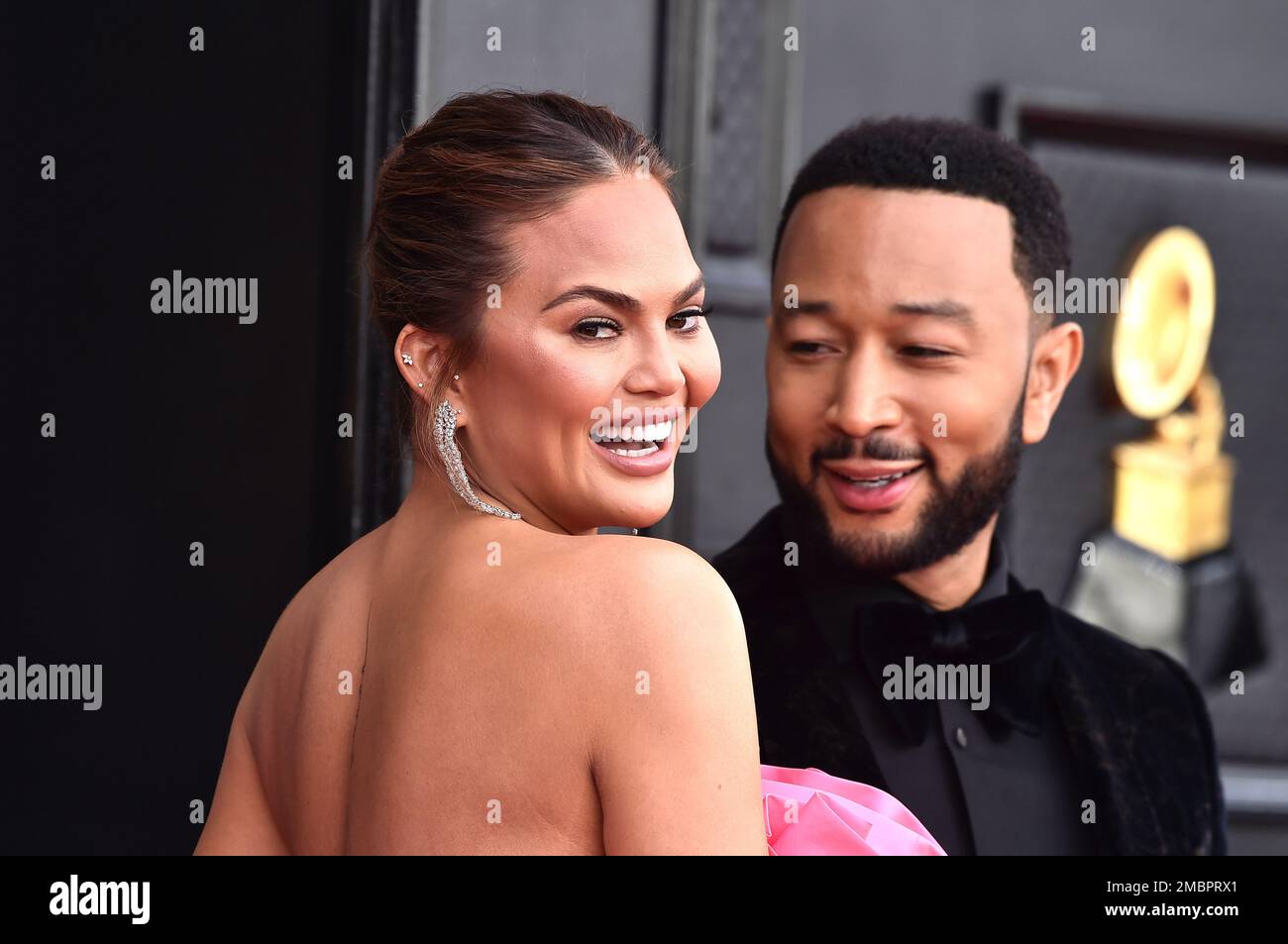 Chrissy Teigen, left, and John Legend arrive at the 64th Annual Grammy ...