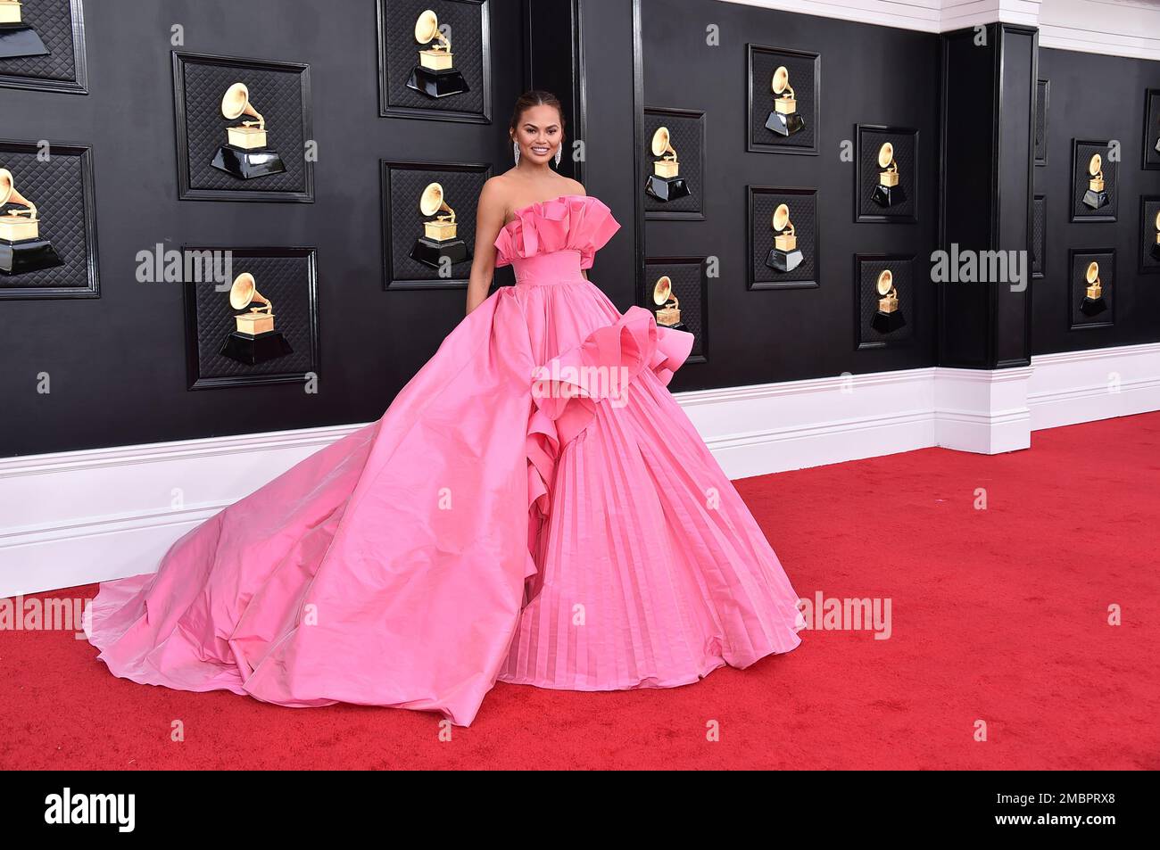 Chrissy Teigen arrives at the 64th Annual Grammy Awards at the MGM ...