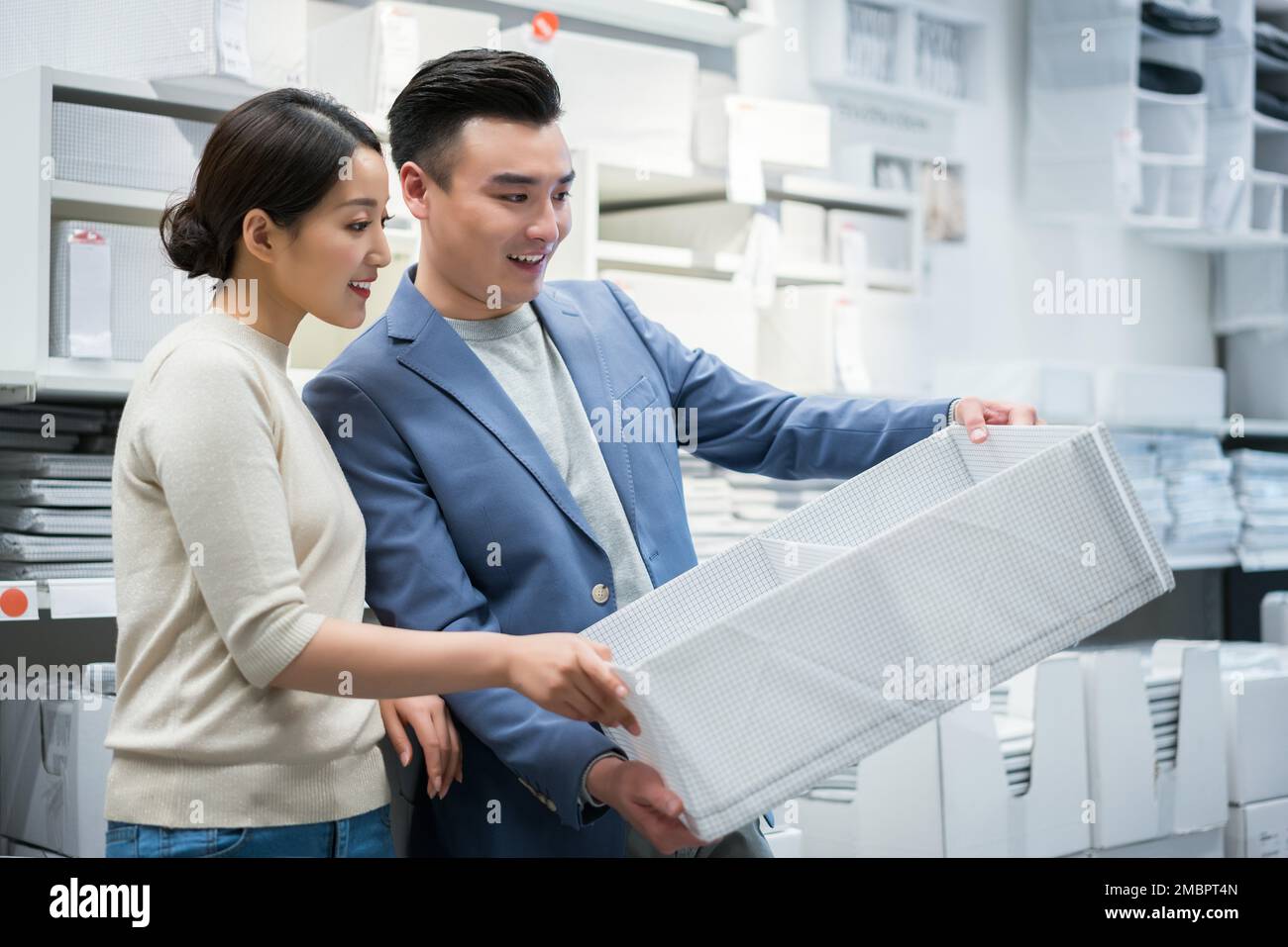 A young couple of choose and buy household items Stock Photo - Alamy