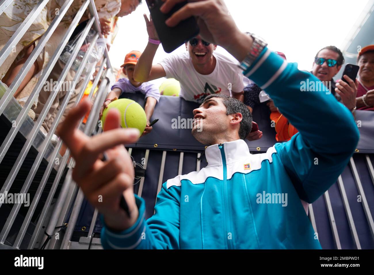 Carlos Alcaraz of Spain takes a selfie with fans as he signs autographs ...