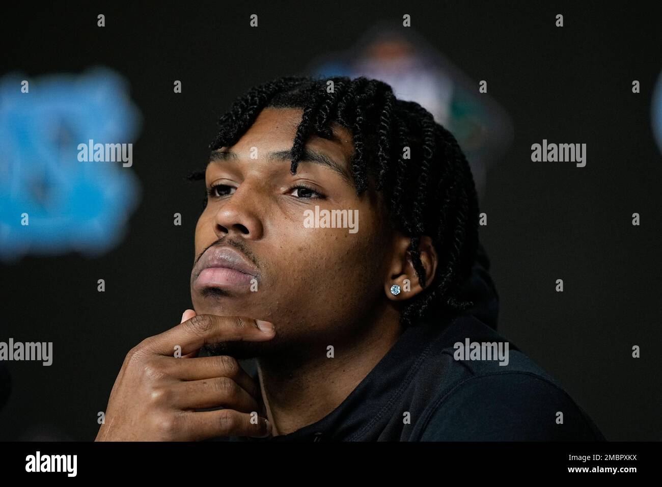 North Carolina guard Caleb Love listens during a news conference about ...