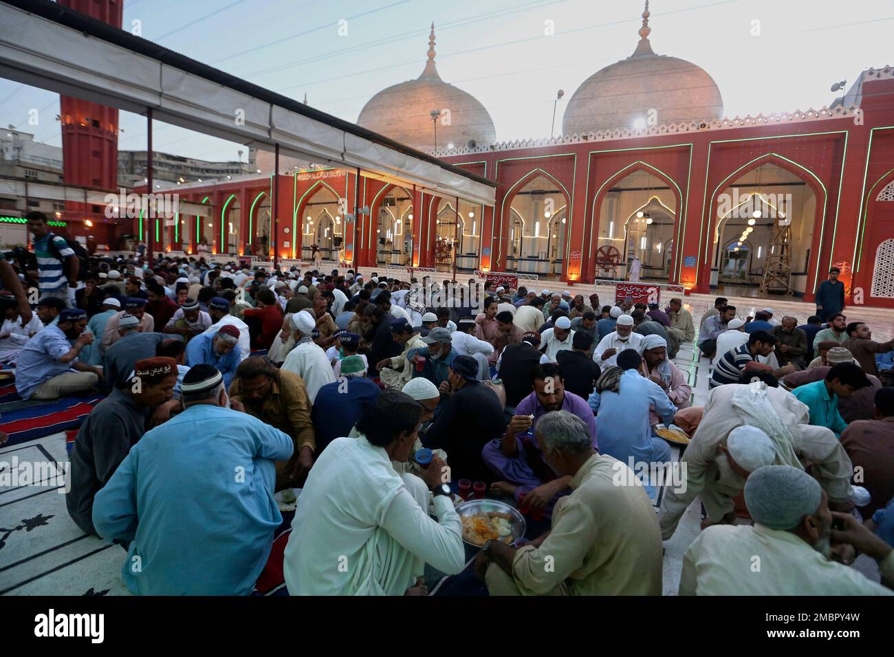 People break their fast at a mosque during the Muslim holy fasting ...
