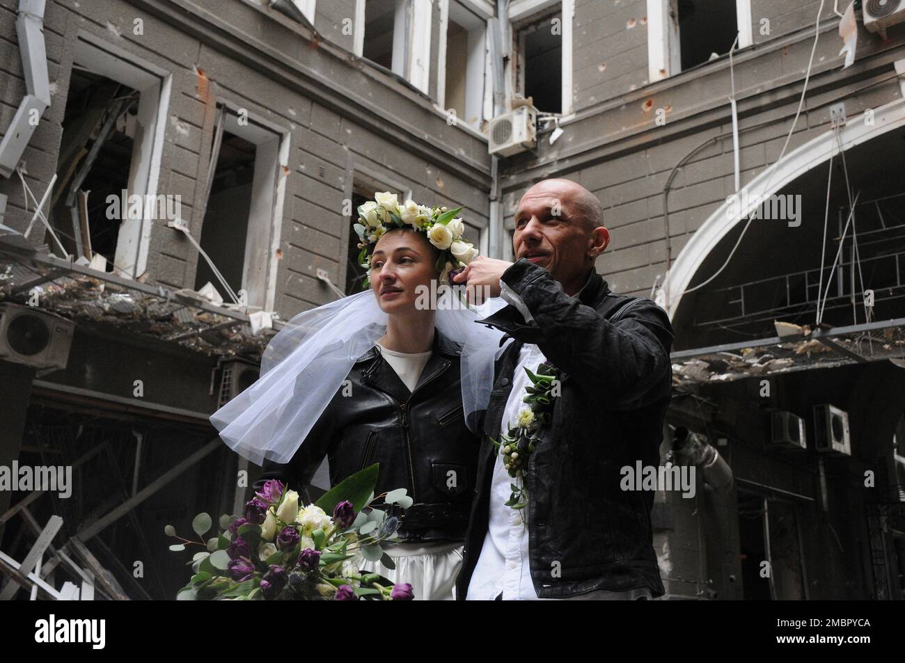 Volunteers Anastasia, left, and Anton pose for a picture in a yard of a ...