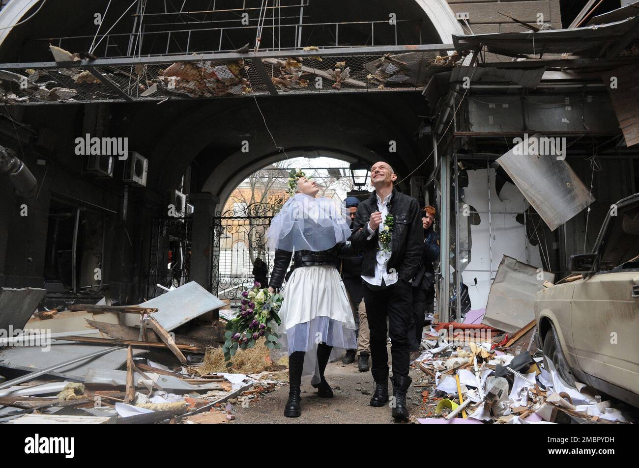 Volunteers Anastasia, left, and Anton pose for a picture in a yard of a ...