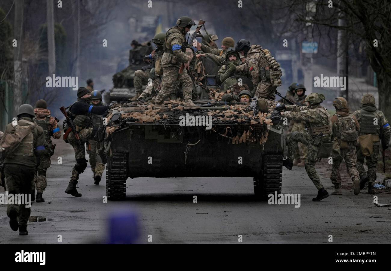Ukrainian servicemen climb on a fighting vehicle outside Kyiv, Ukraine ...