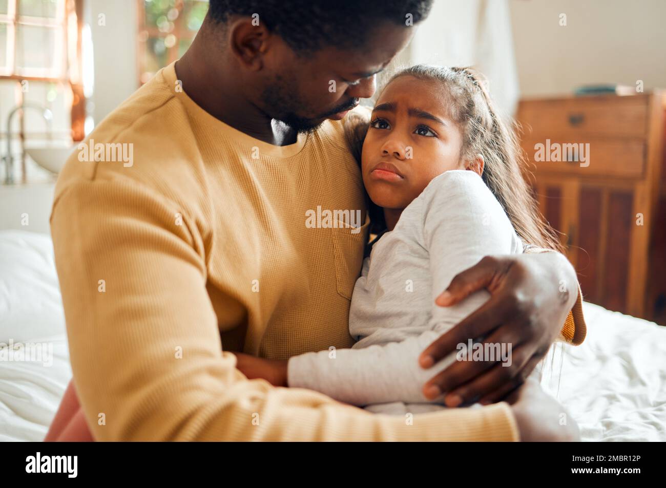 Sick, sad and father holding his child with an illness, pain or problem ...