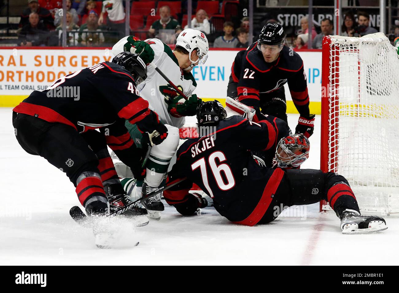 Carolina Hurricanes' Brett Pesce (22), Brady Skjei (76), and Jordan Martinook (48) help ...